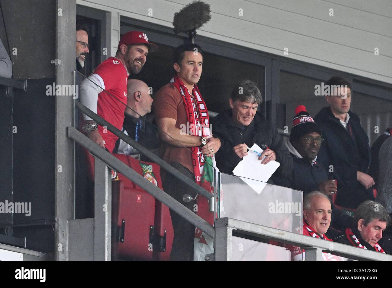 Wrexham co-owner Rob McElhenney (centre) watches on from the stands ...