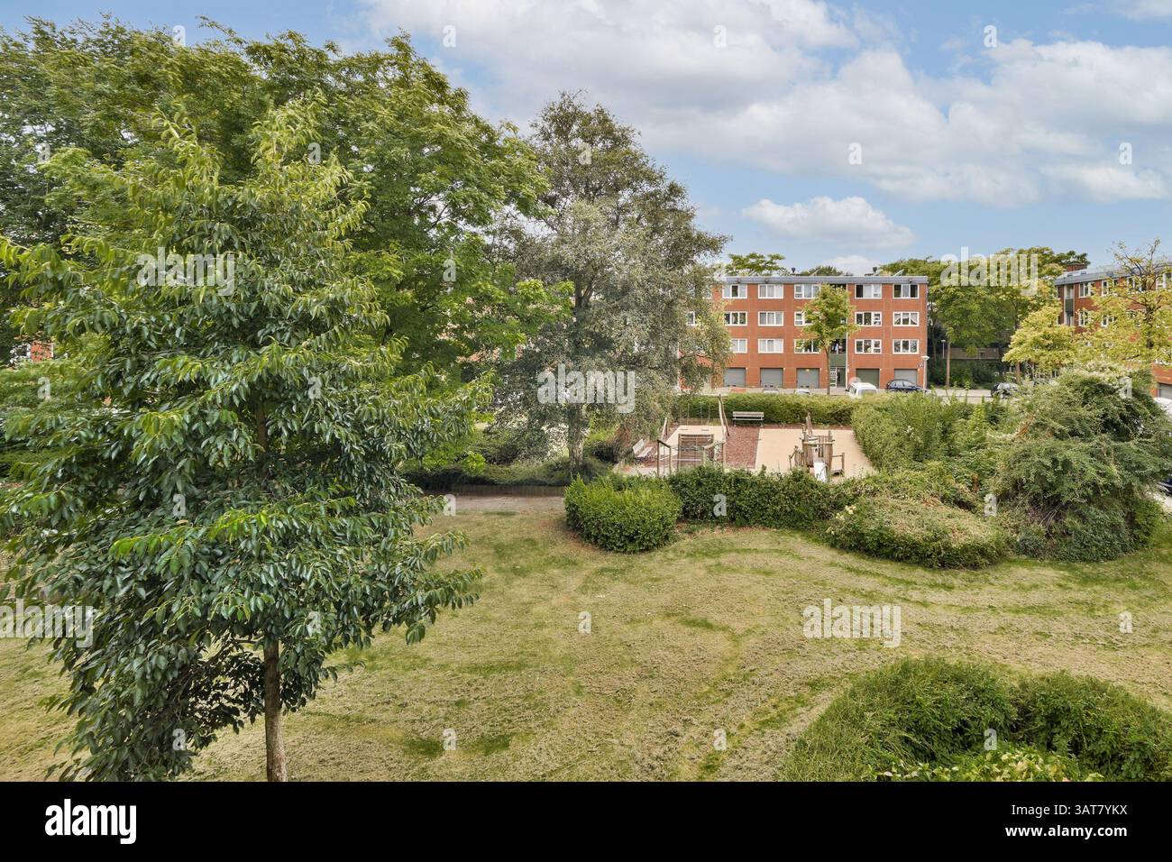 Lush greenery surrounds well-maintained pathways in an urban park ...