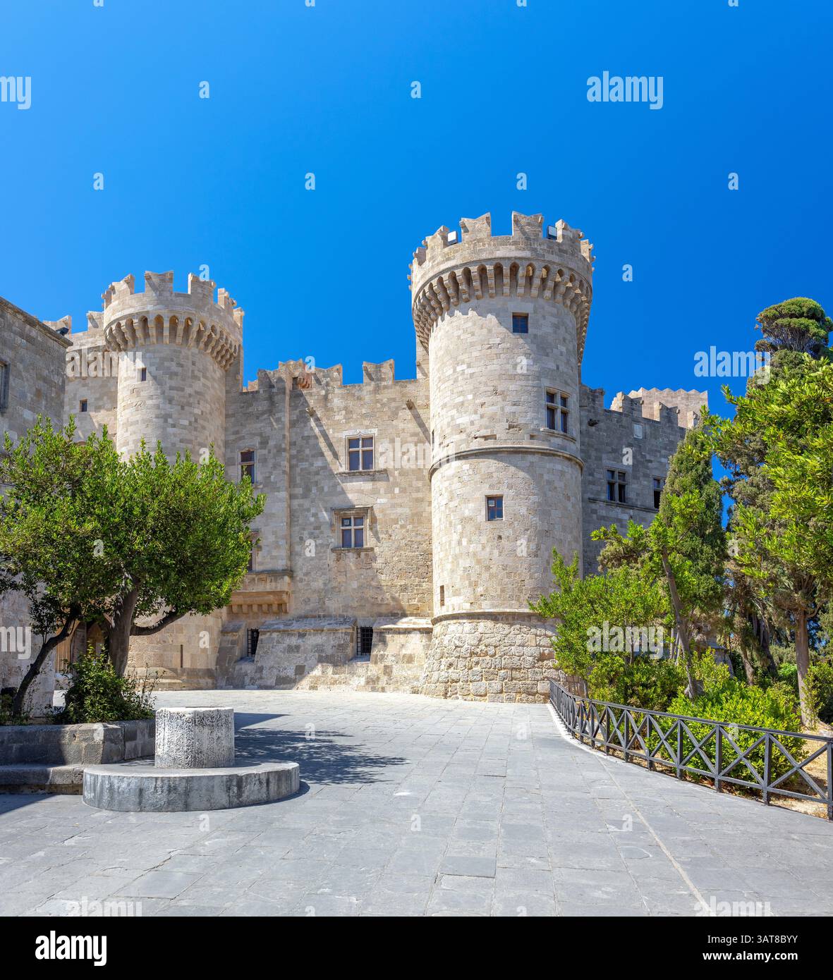 A sunny, low-angle shot captures the stone facade and round towers of ...