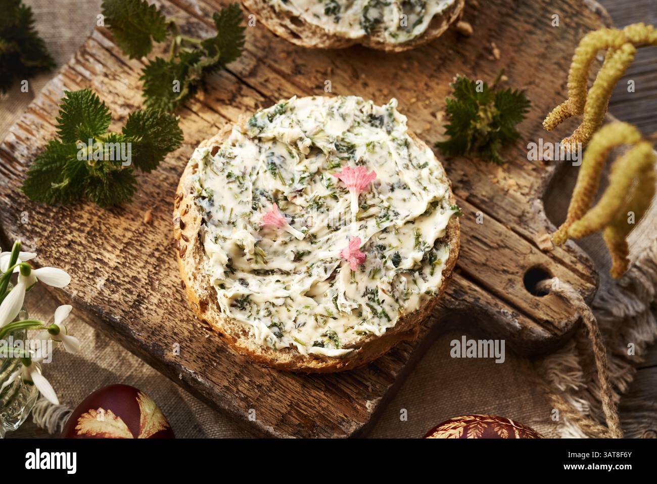 Nettle butter - homemade bread spread on slices of bun with spring ...