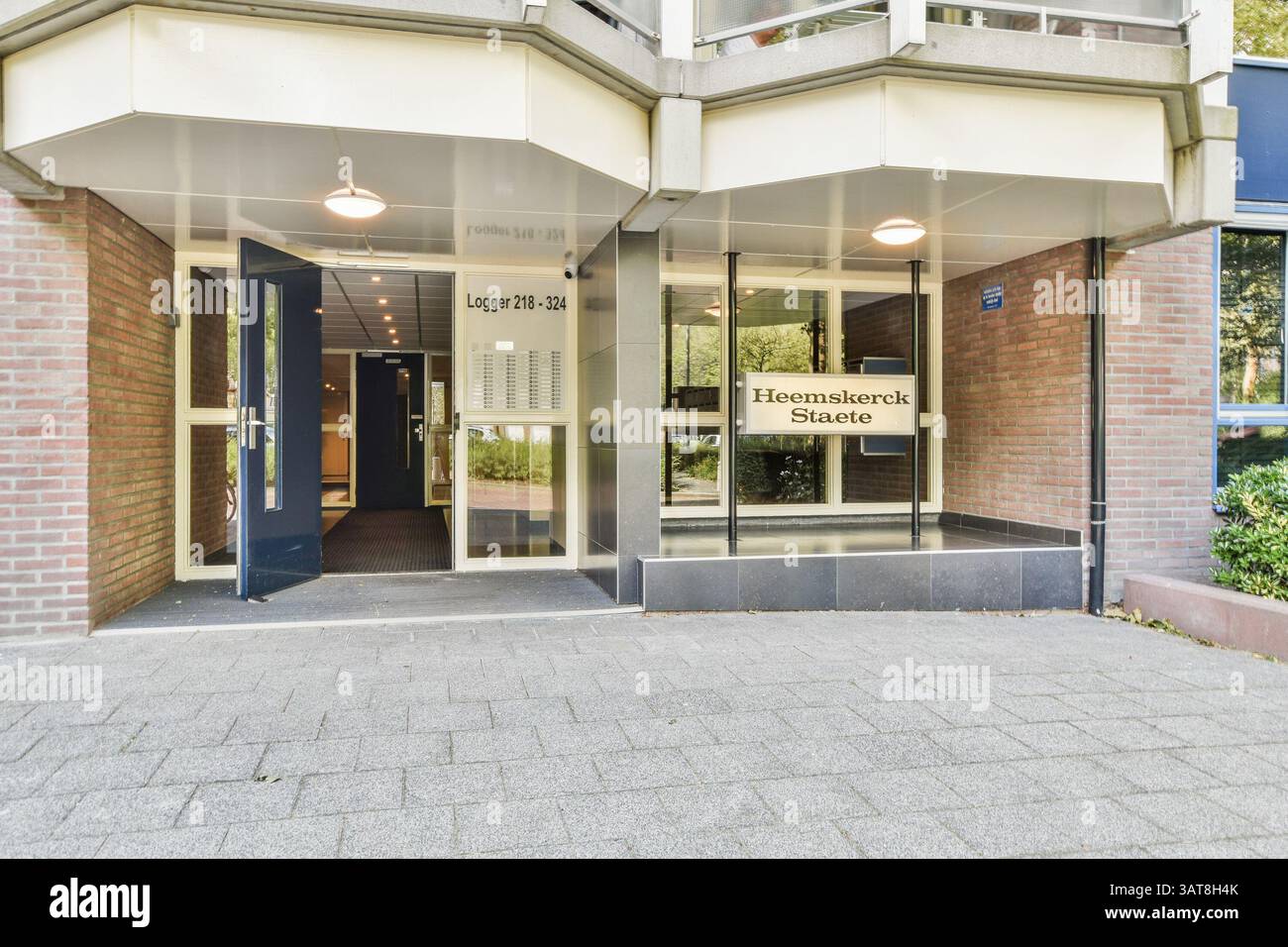 A sleek and modern entrance to a building featuring large glass doors ...
