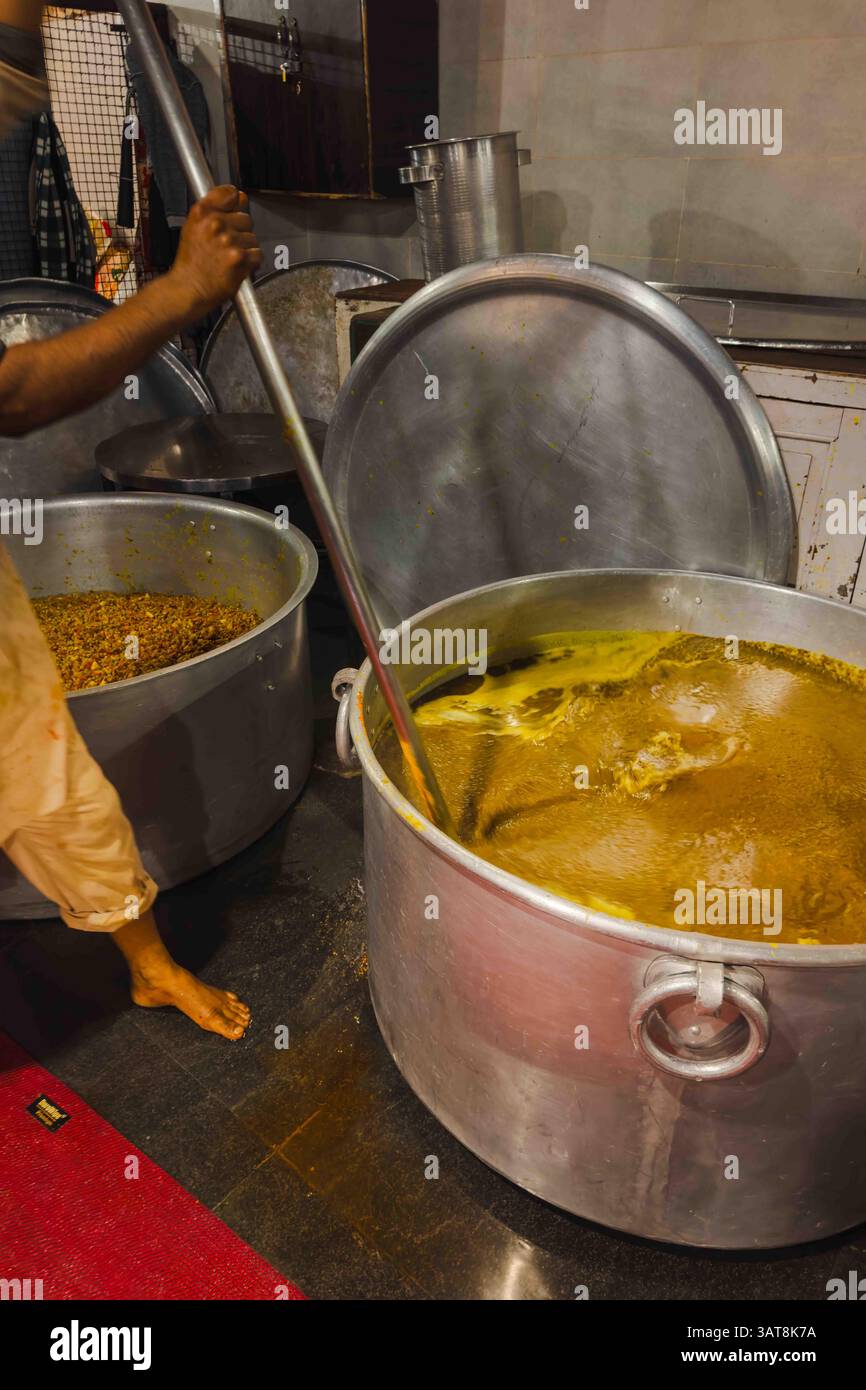 Volunteers cooking dahl for the masses of pilgroms visiting the free ...