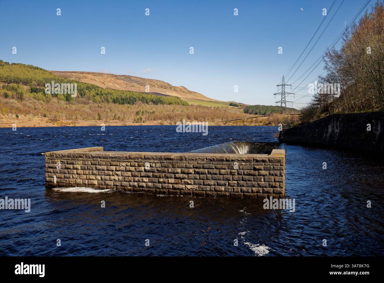 Choppy waters of Rhodeswood Reservoir on a windy day sending cascades ...
