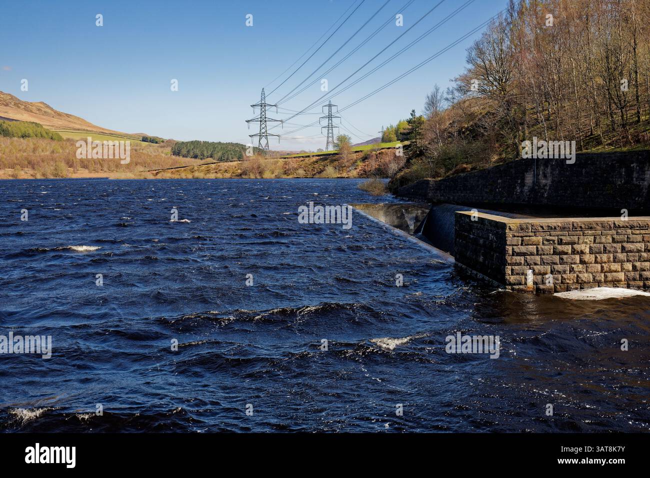 Choppy waters of Rhodeswood Reservoir on a windy day sending cascades ...