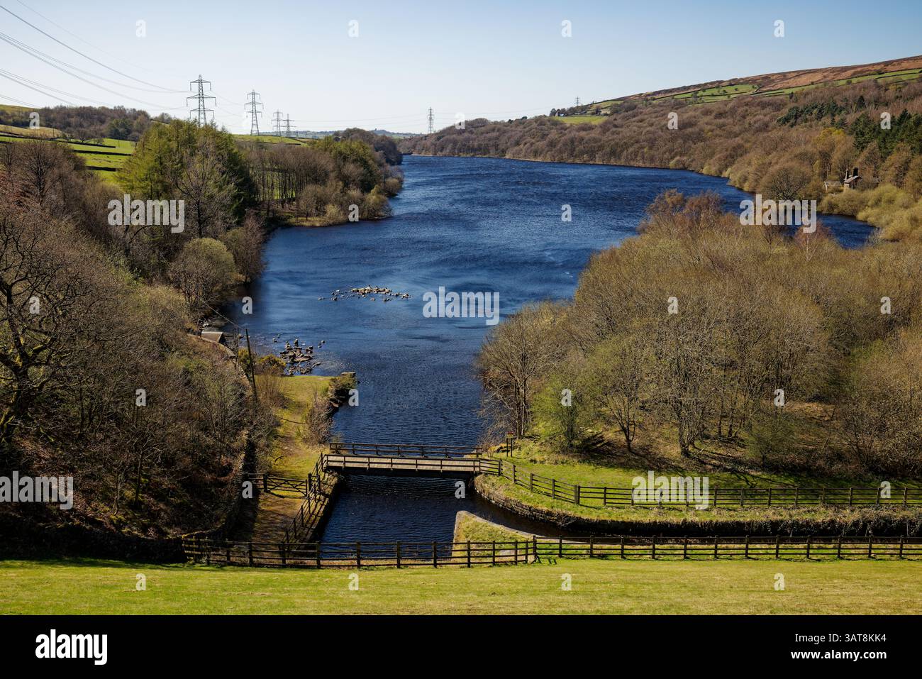 The blue waters of Valehouse Reservoir occupy the flooded bottom of ...
