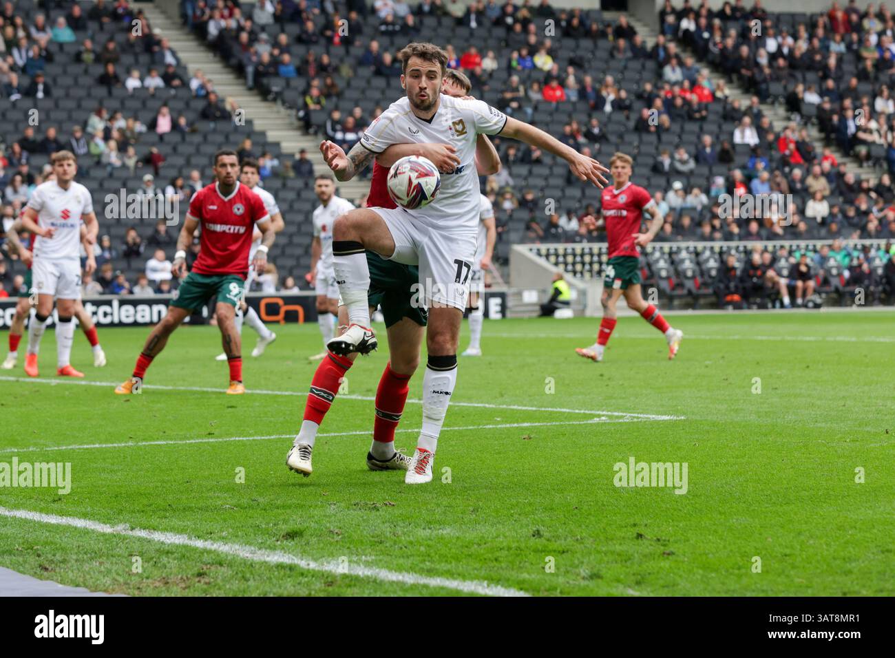 MK Dons Luke Offord is challenged by Newport County's Ciaran Brennan during the first half of ...
