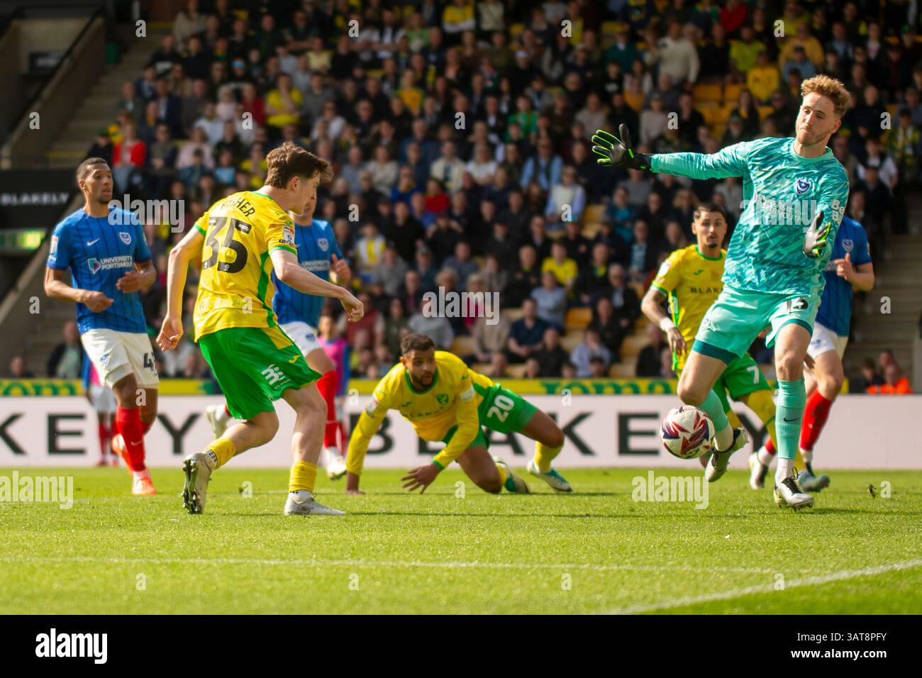 Nicolas Schmid of Portsmouth makes a save from Kellen Fisher of Norwich ...