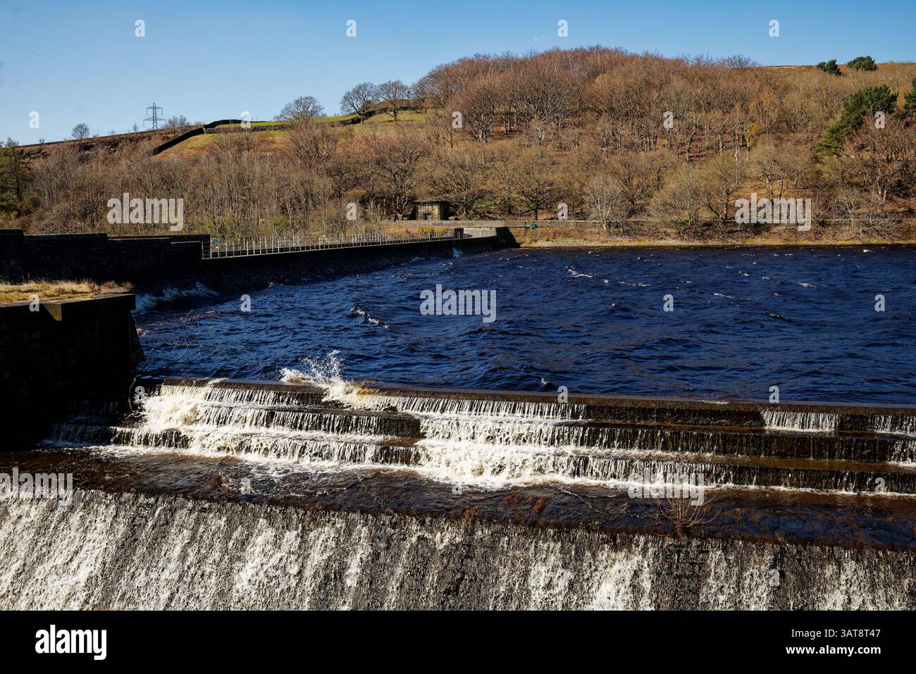Water cascading down the overflow spillway of Rhodeswood Reservoir ...