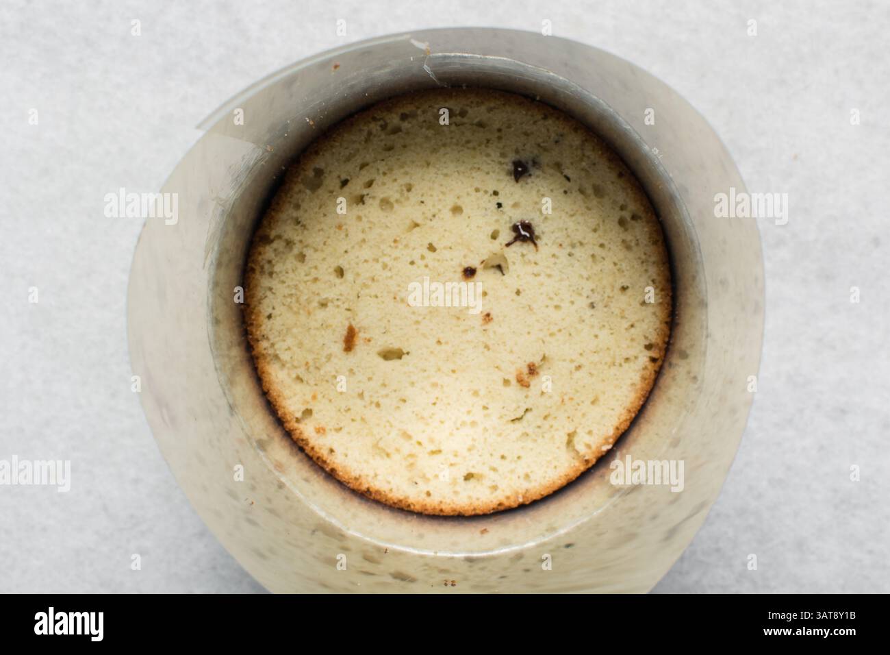 overhead view of layered cake being filled with chocolate ganache, top ...