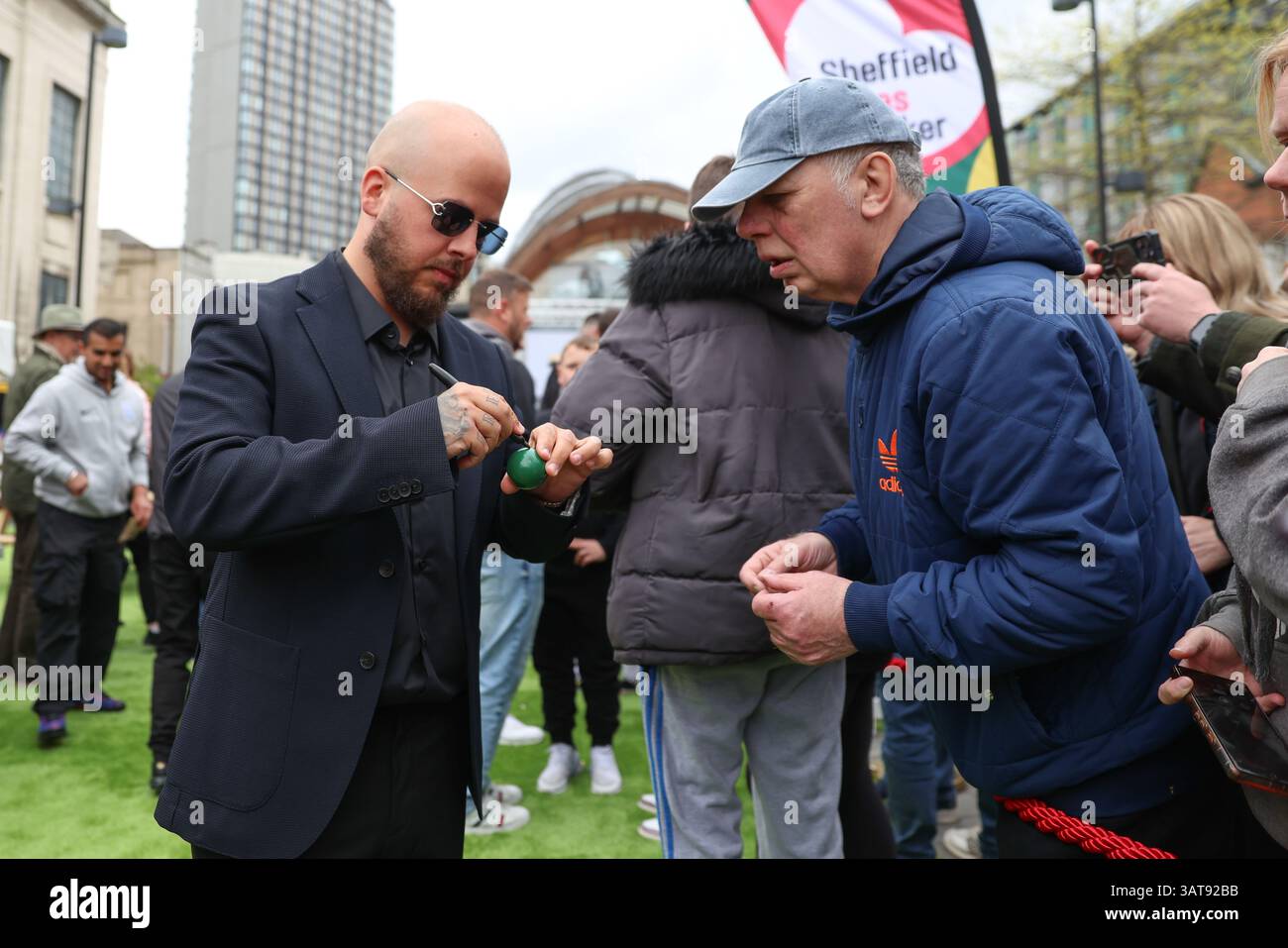 Luca Brecel signs a snooker ball during the 2025 Halo World Snooker ...