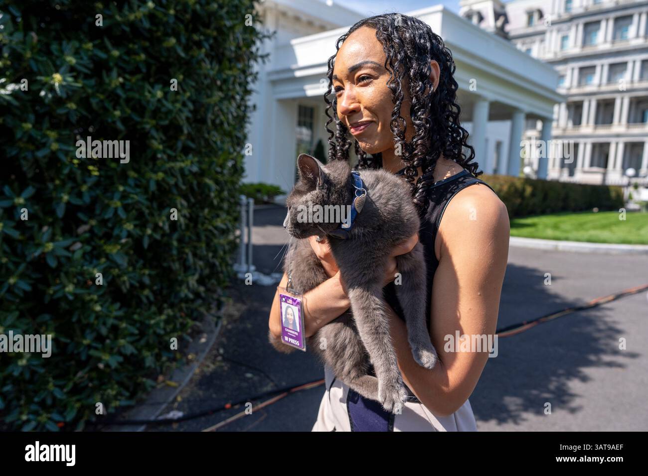 Sophie, a cat that wandered onto the White House grounds, is held by ...