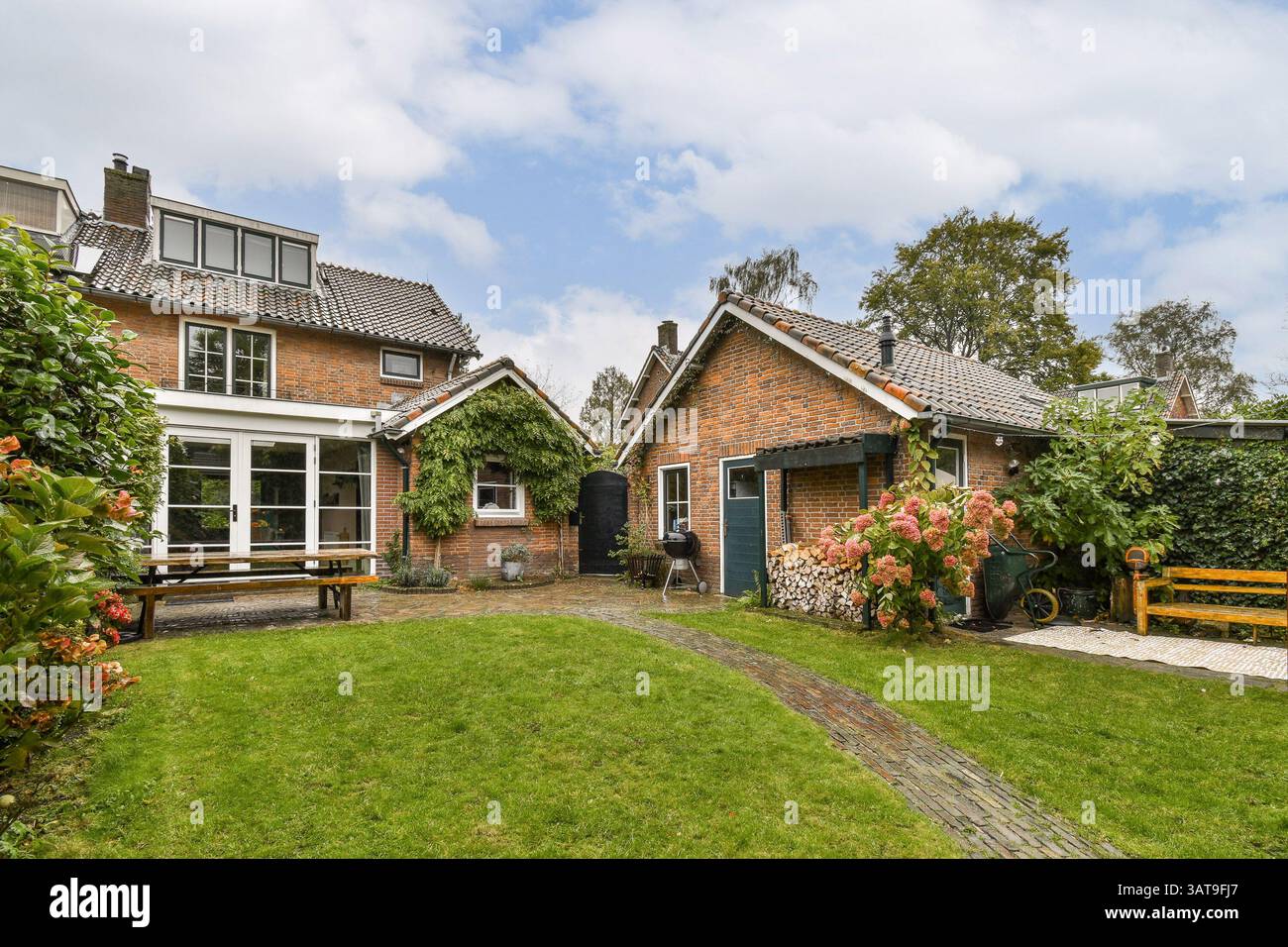 A picturesque residential scene featuring two cozy houses surrounded by ...