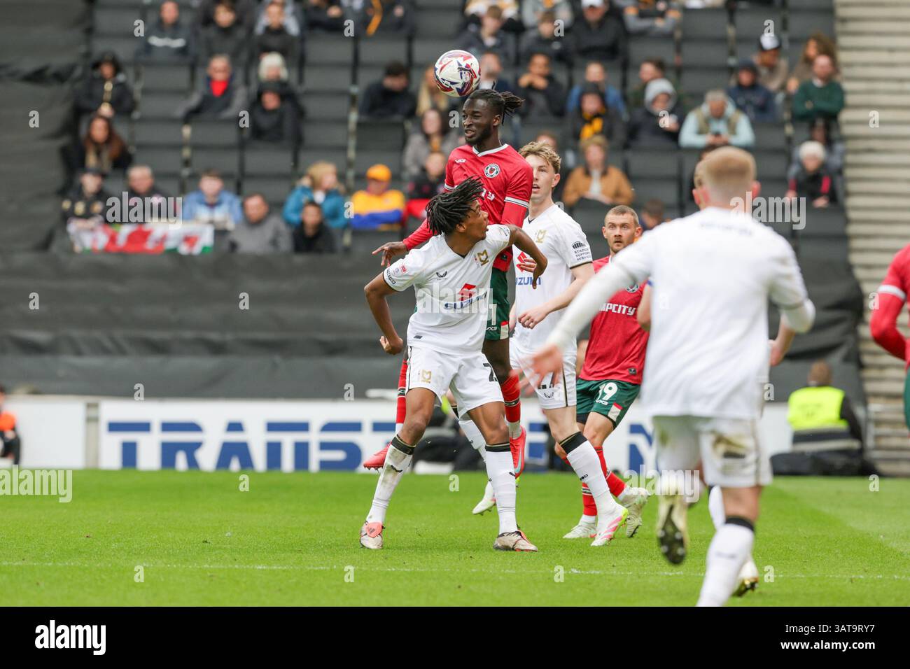 MK Dons Kane Thompson-Sommers and Newport County's Cameron Antwi battle ...