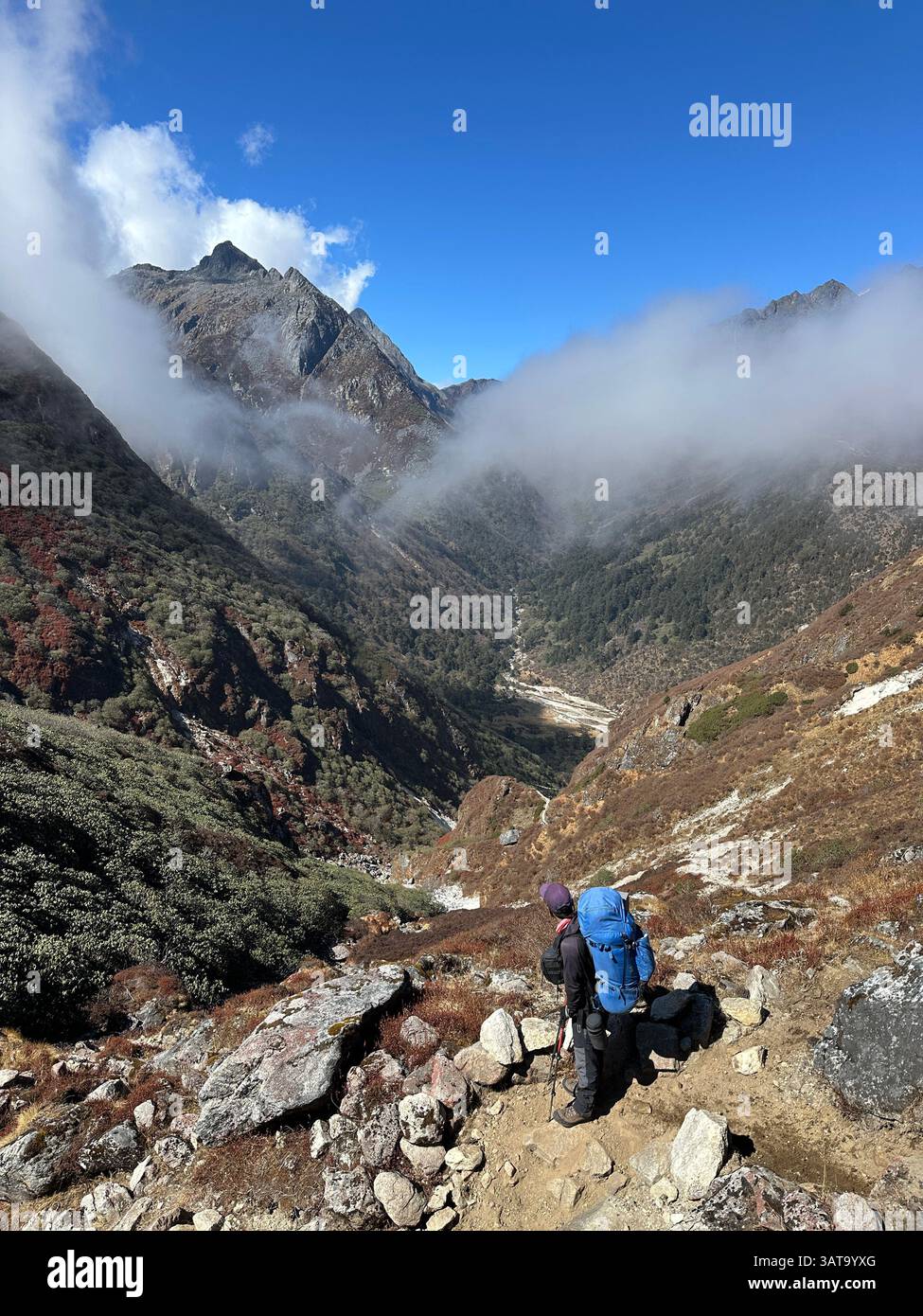 Side view of a climber on a climbing expedition in the mountains ...