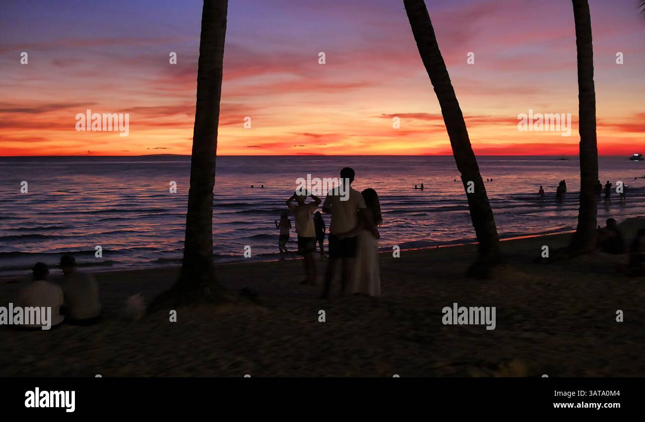 Vacationers enjoy the scenic sunset and tranquil waters at Boracay ...