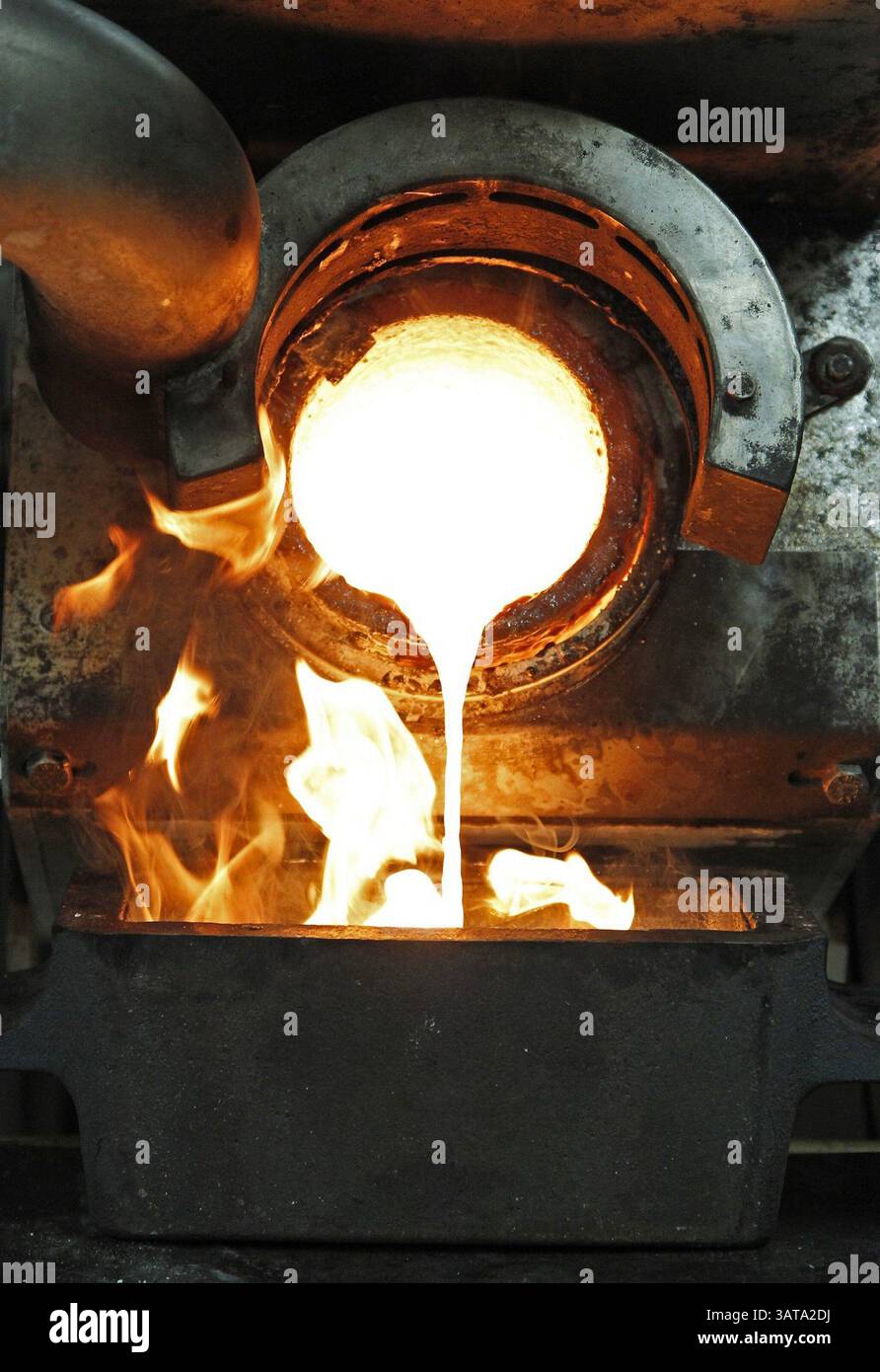 June 24, 2013 - Miami, FL, USA - Molten gold is poured into a metal ...