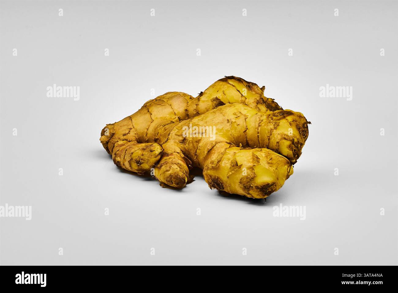 Fresh ginger root with peel isolated on white background with space for ...