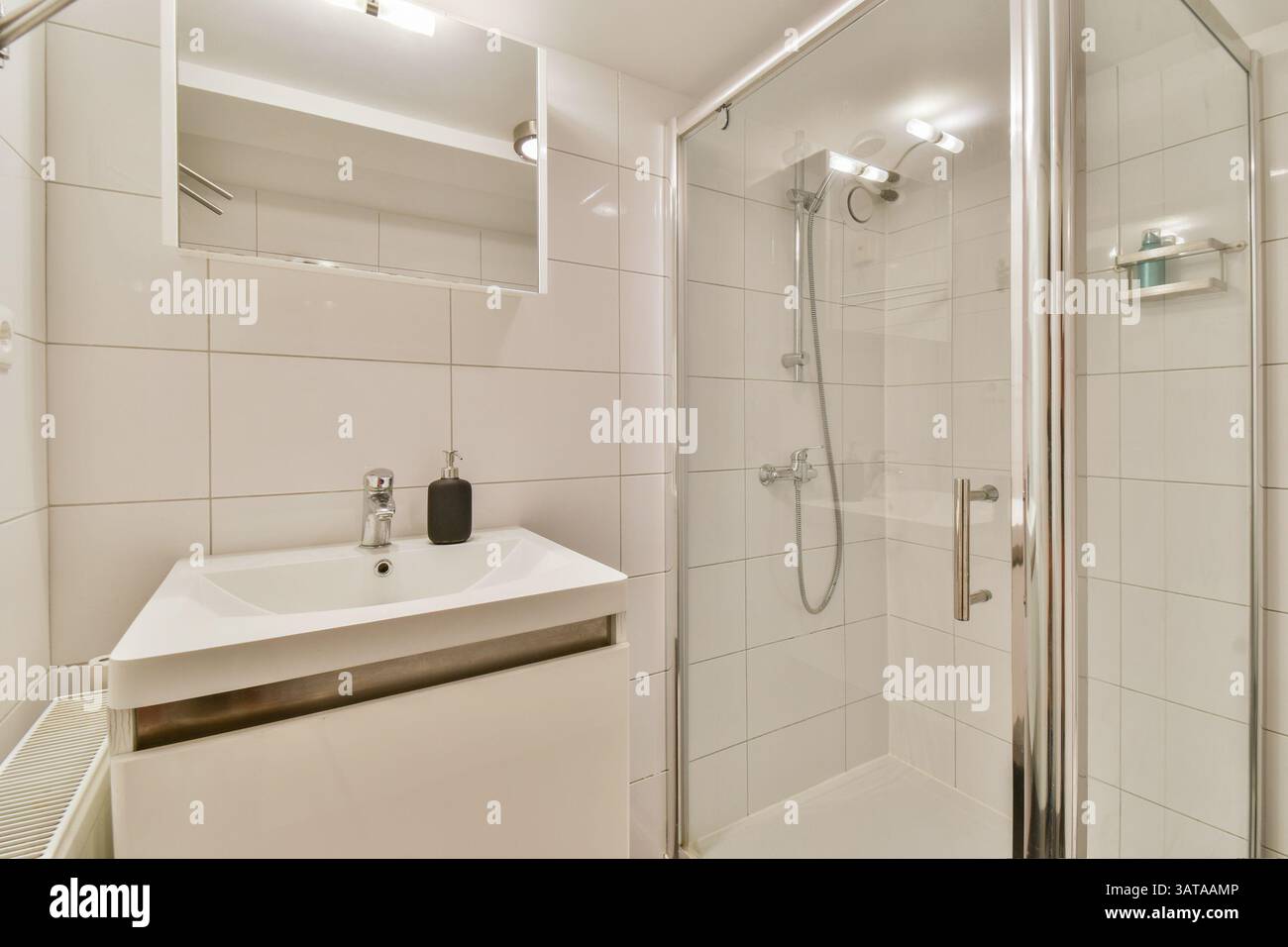 Features a sleek, modern bathroom setup showcasing a shower stall ...