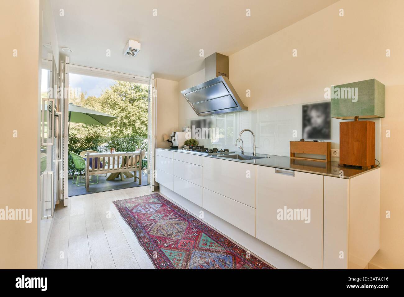 A stylish modern kitchen featuring sleek cabinetry, a functional layout ...