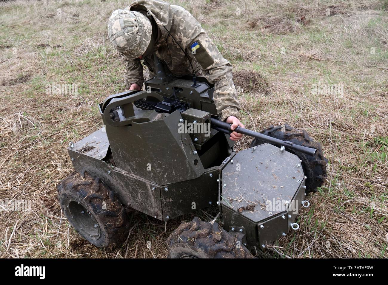 A cadet equips a Liut (Rage) combat ground robotic complex with a ...
