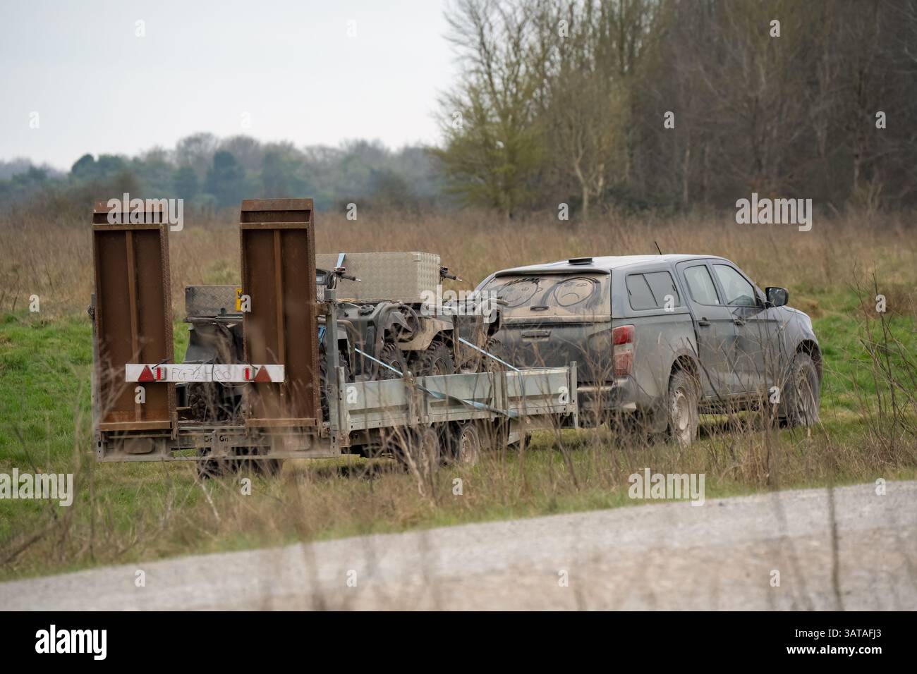 a pair of quad bikes on a trailer behind a toyota hilux invincible ...