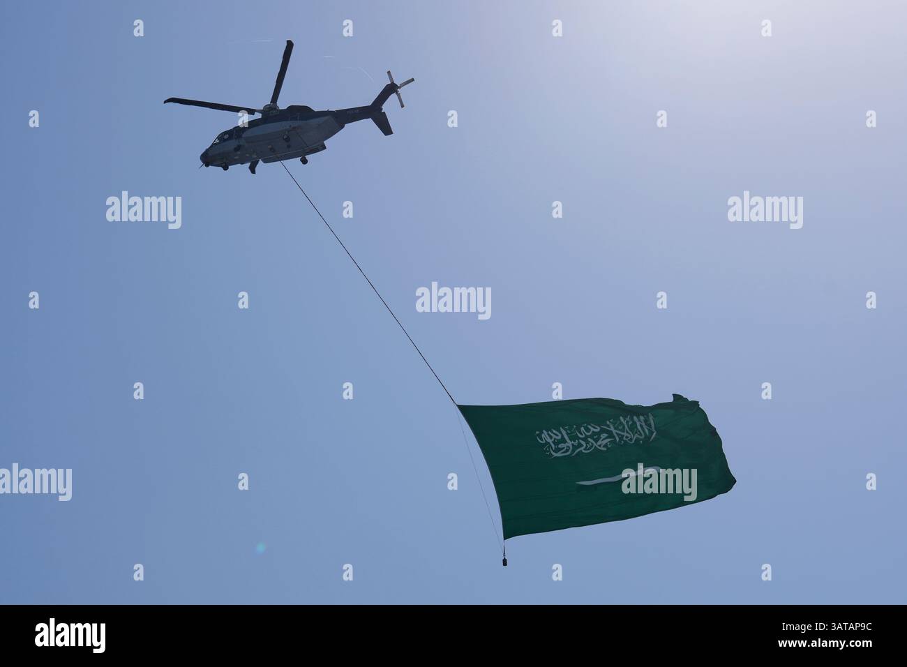 An helicopter carrying a Saudi Arabia flag flies over the Jeddah ...