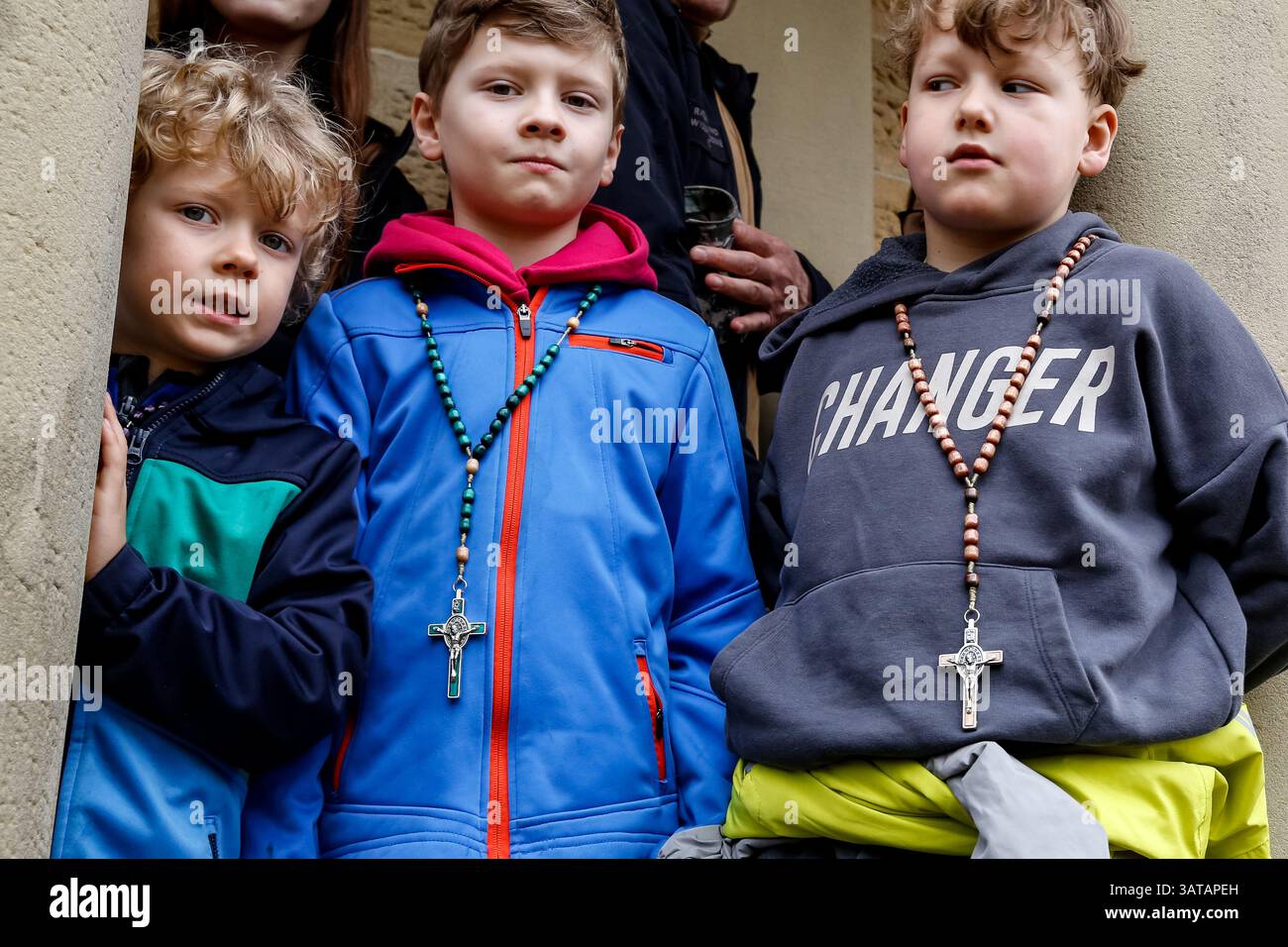 Children with crosses on their necks attend the procession in the Way ...