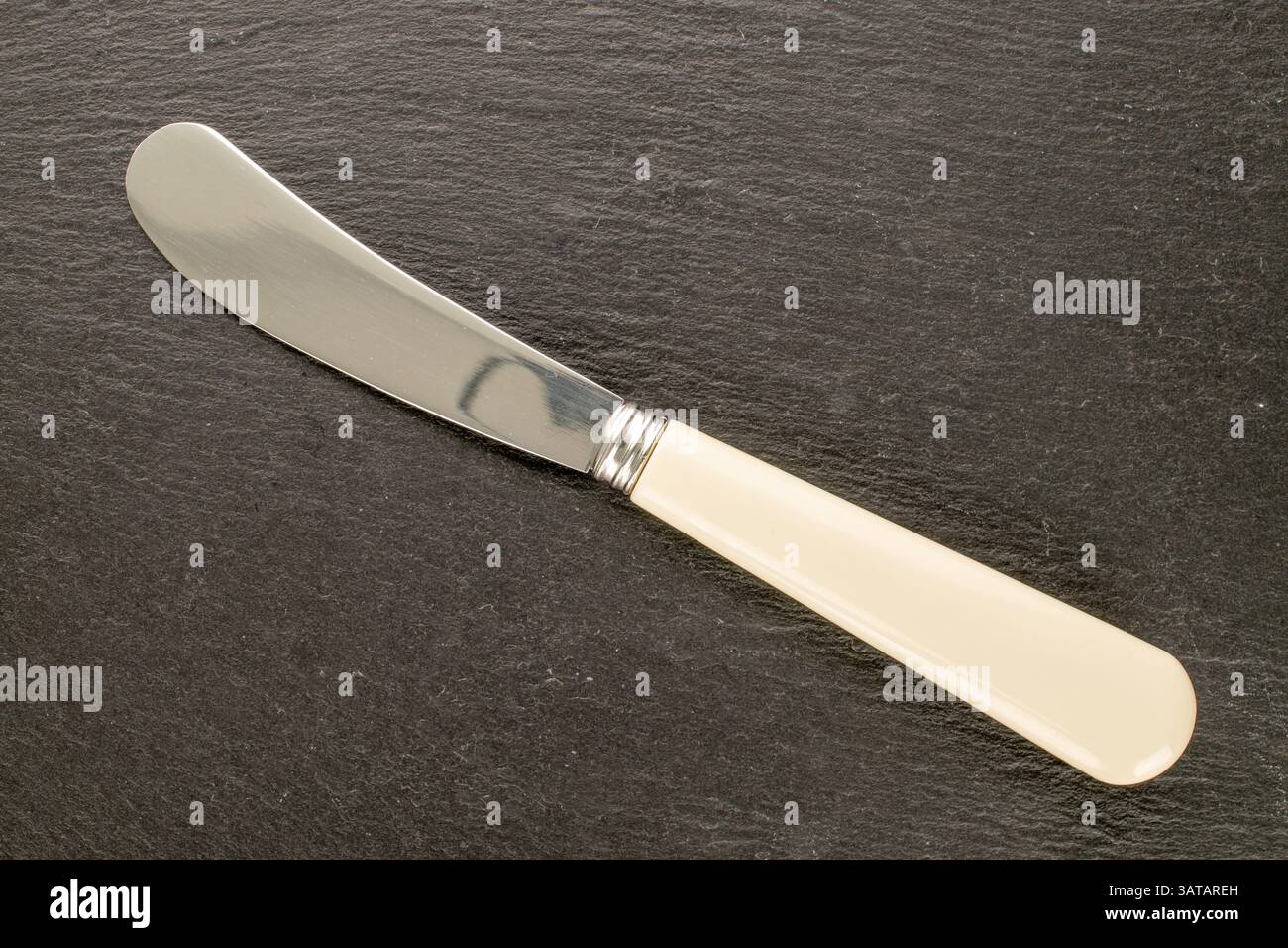 One butter knife on a slate stone, close-up, top view Stock Photo - Alamy