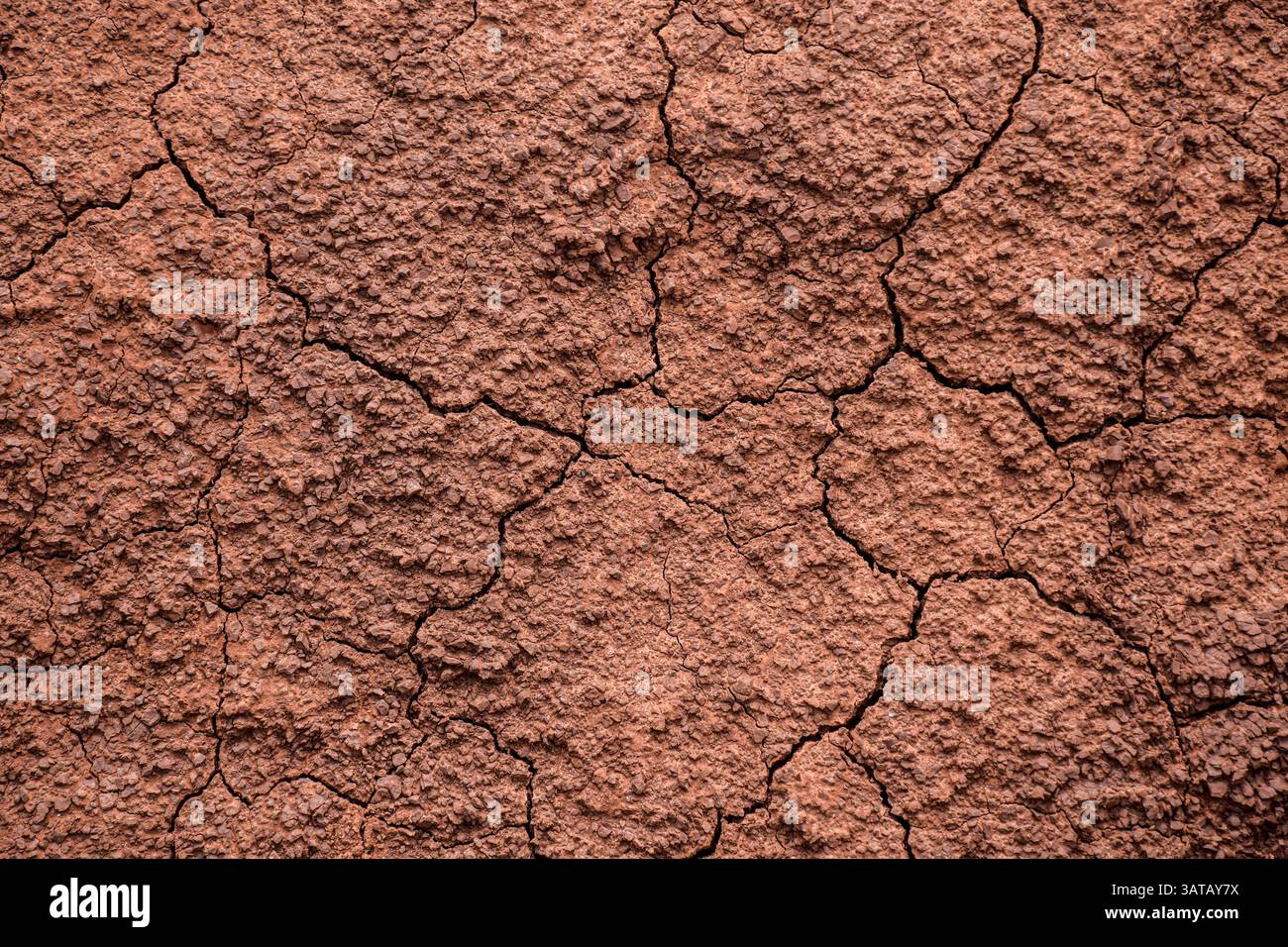 Cracked dry red clay soil background Stock Photo - Alamy