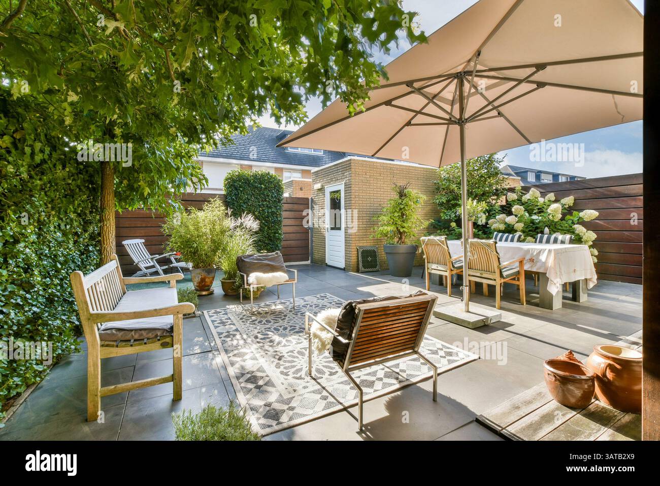 A beautifully designed outdoor patio featuring lush greenery ...