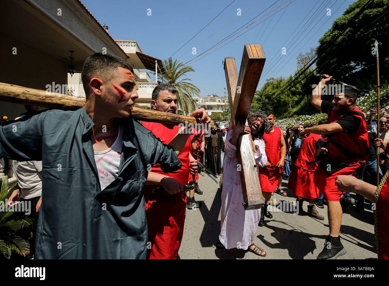 18 April 2025, Lebanon, Qraiyeh: A Christian youth, portraying Jesus ...