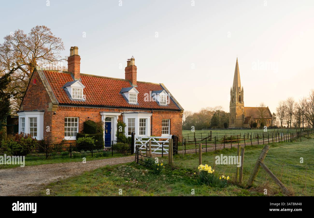 St Leonard's church flanked by cottage surrounded by grass and trees on ...