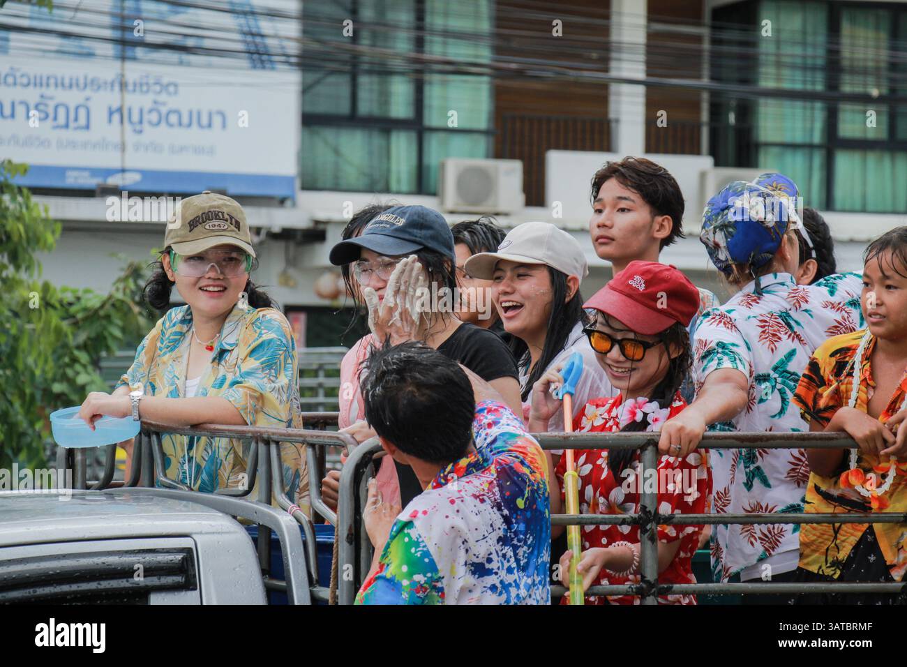A man is painting talcum powder on the face of a woman who is visiting ...