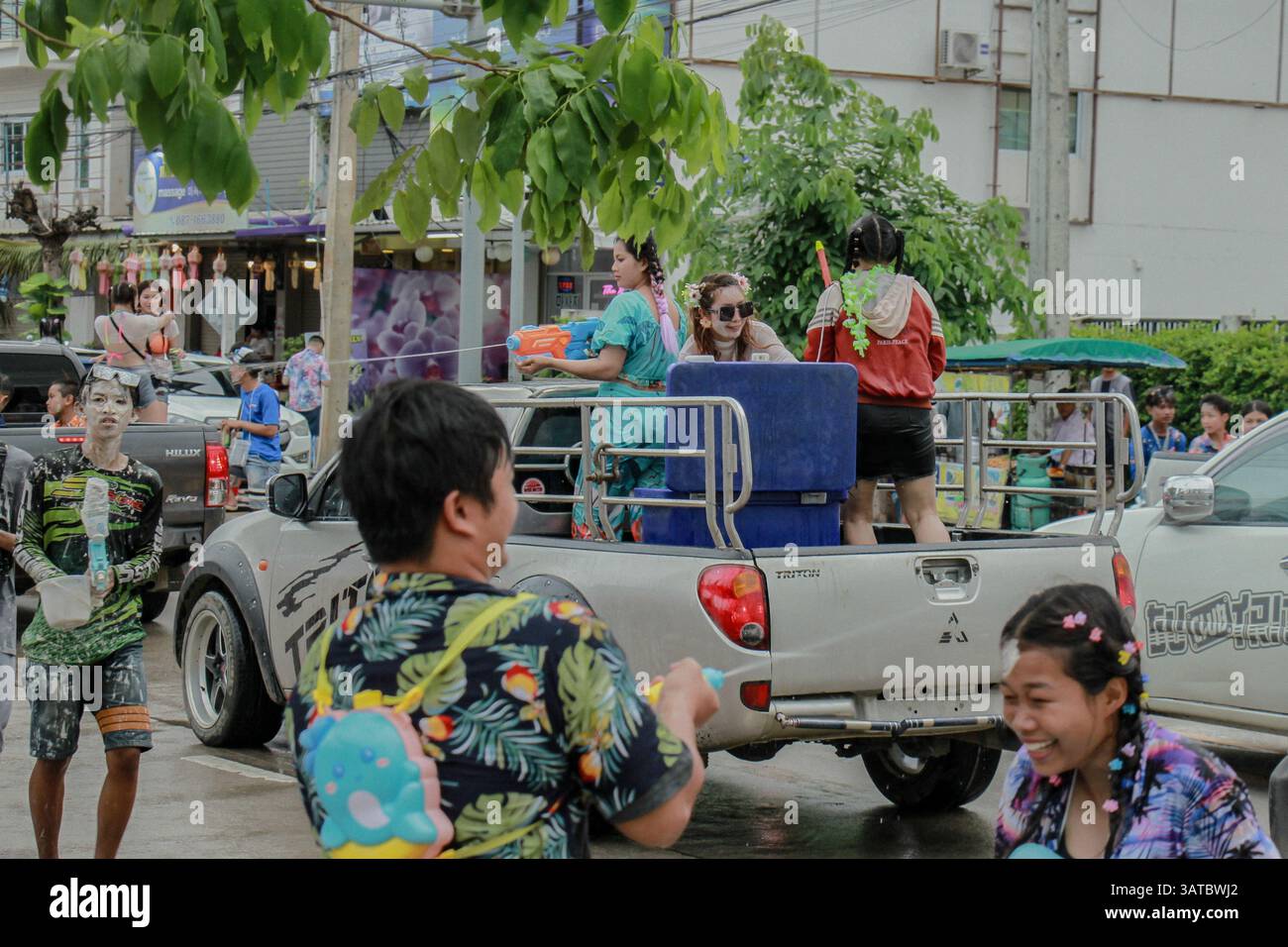 Revellers join in the Songkran celebrations near the Robinson shopping ...