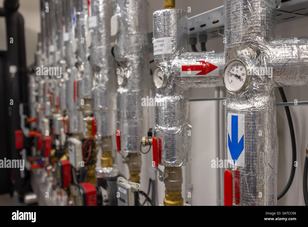 Industrial pipes and valves regulating temperature in a heating system ...