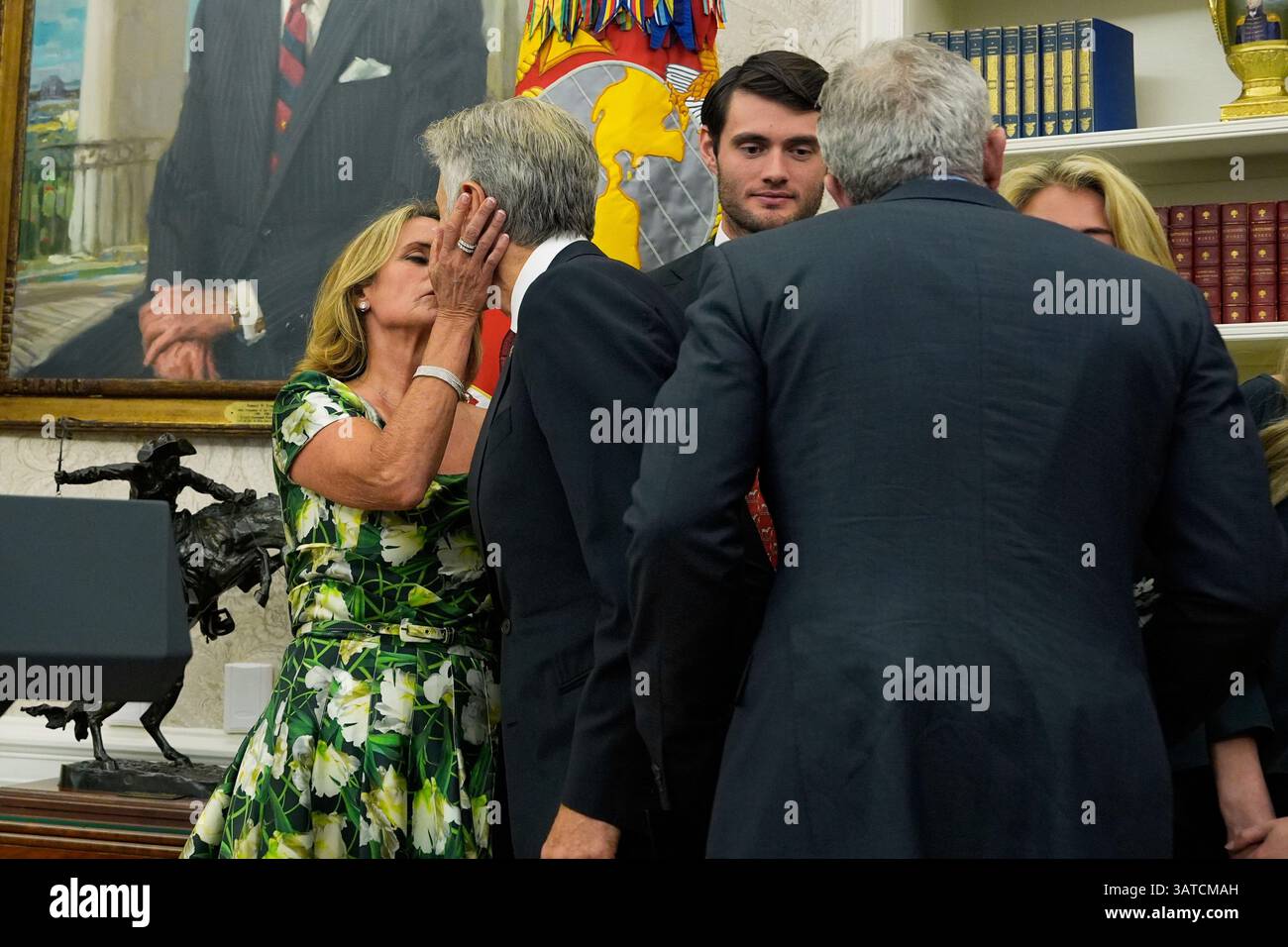 Lisa Oz, from left, kisses her husband Dr. Mehmet Oz as son Oliver Oz looks on at a swearing in ...
