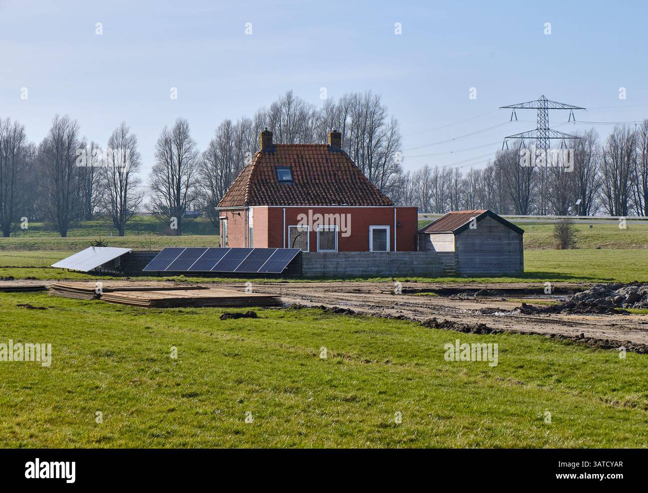 March 5, 2025 - Warga-Netherlands: Small rural house near windmill with ...