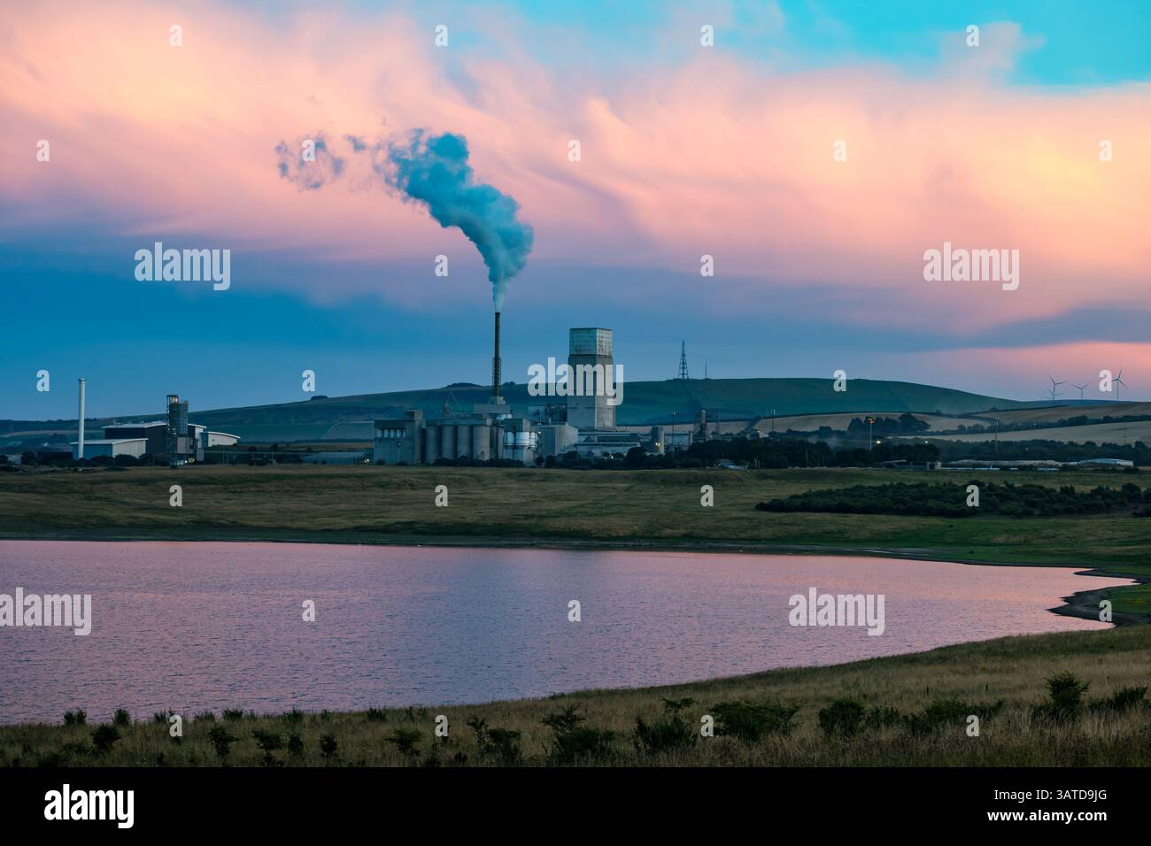 View of Dunbar cement works with steam vapour rising from industrial ...