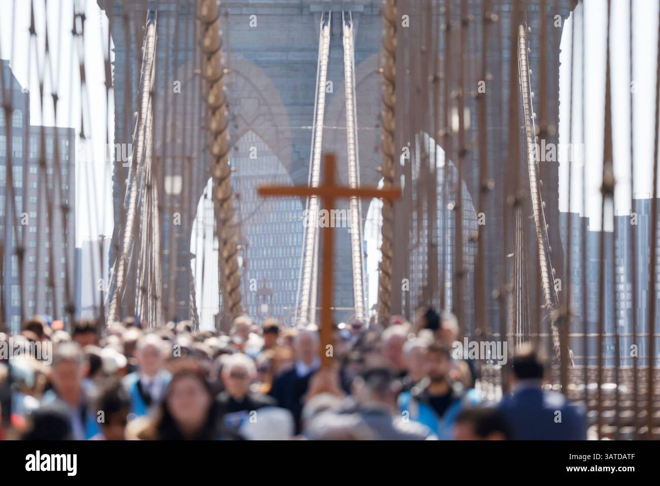 New York, United States. 18th Apr, 2025. A wooden cross leads a ...