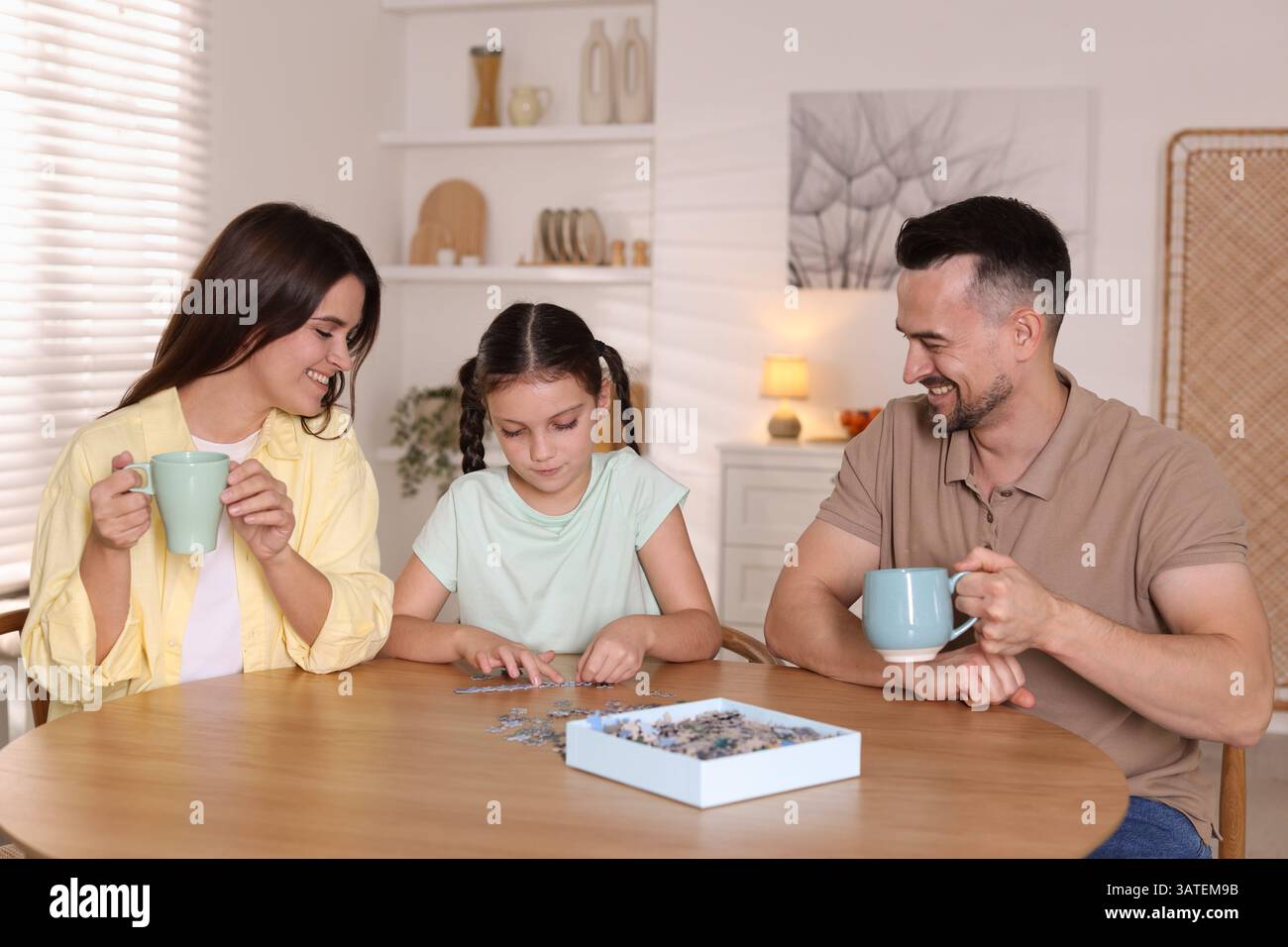 Happy parents daughter solving hi-res stock photography and images - Alamy