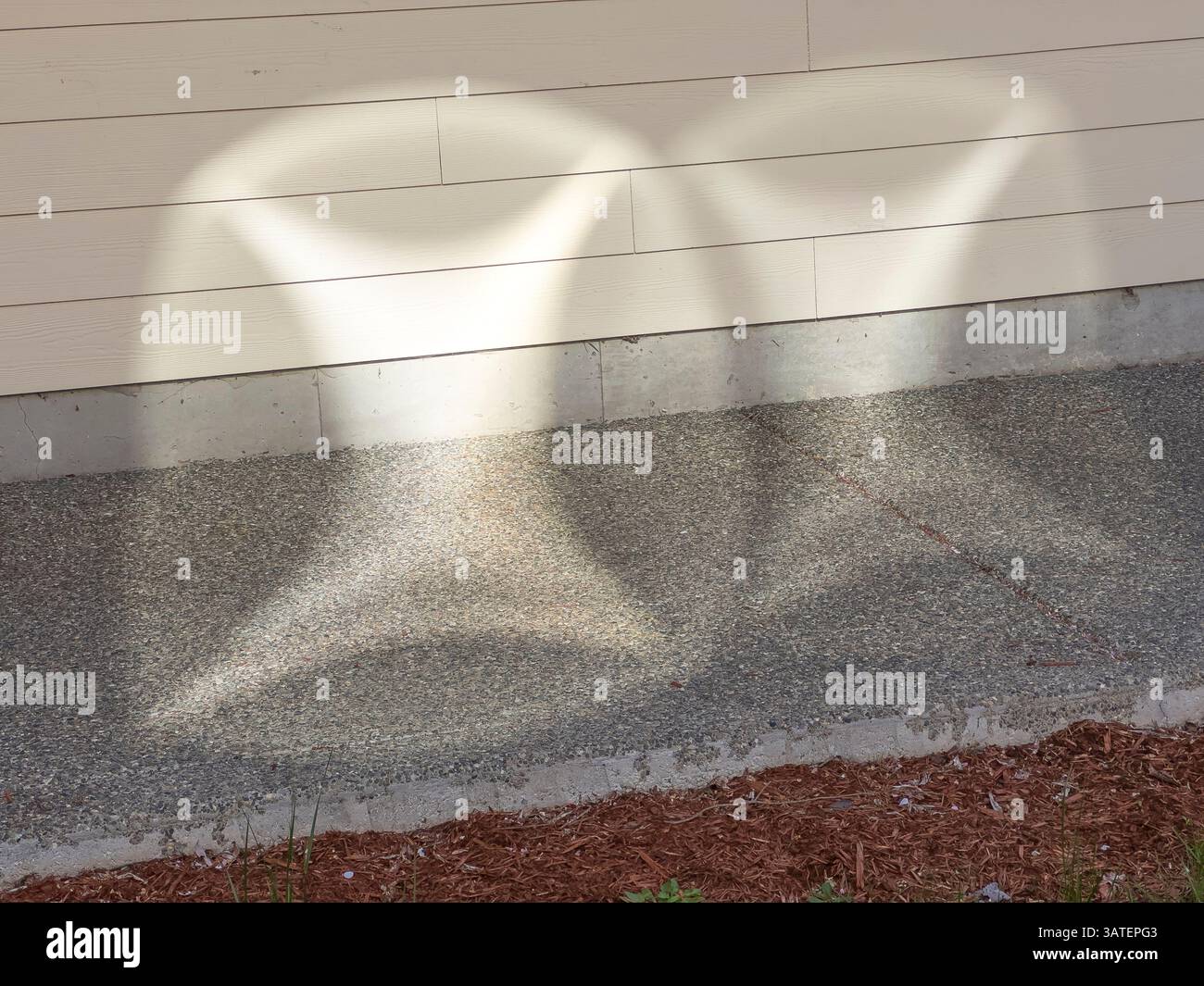 Unusual Reflections on a wall and concrete walkway Stock Photo - Alamy