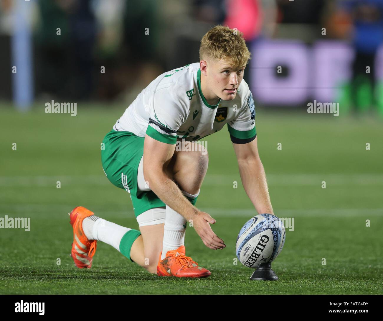 Northampton Saints’ Fin Smith places the ball before attempting a ...