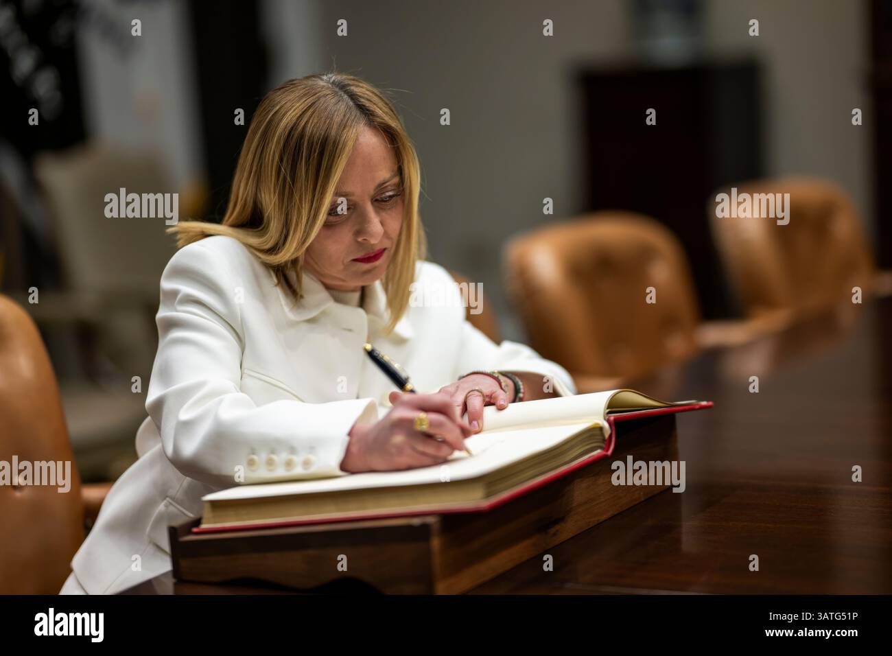 Prime Minister Giorgia Meloni of Italy signs the guest book in the ...