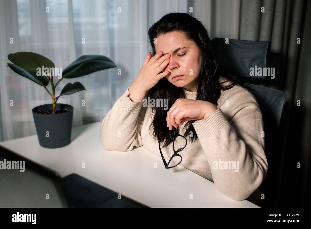Young freelancer working from home feeling tired after working whole ...