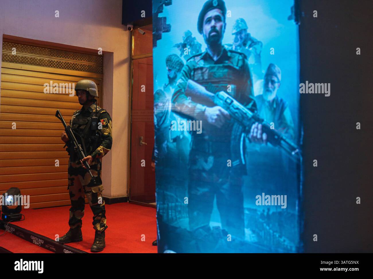 An Indian Border Security Force (BSF) soldier stands guard next to a ...