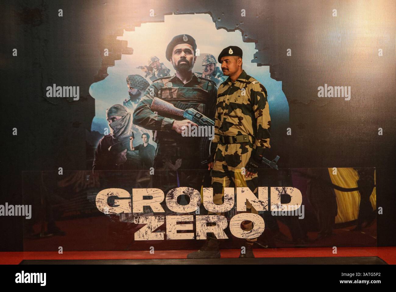 An Indian Border Security Force (BSF) soldier stands next to a ...