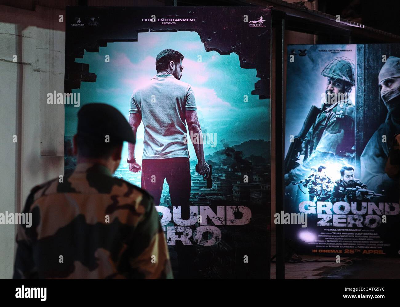 An Indian Border Security Force (BSF) soldier walks past billboards of ...