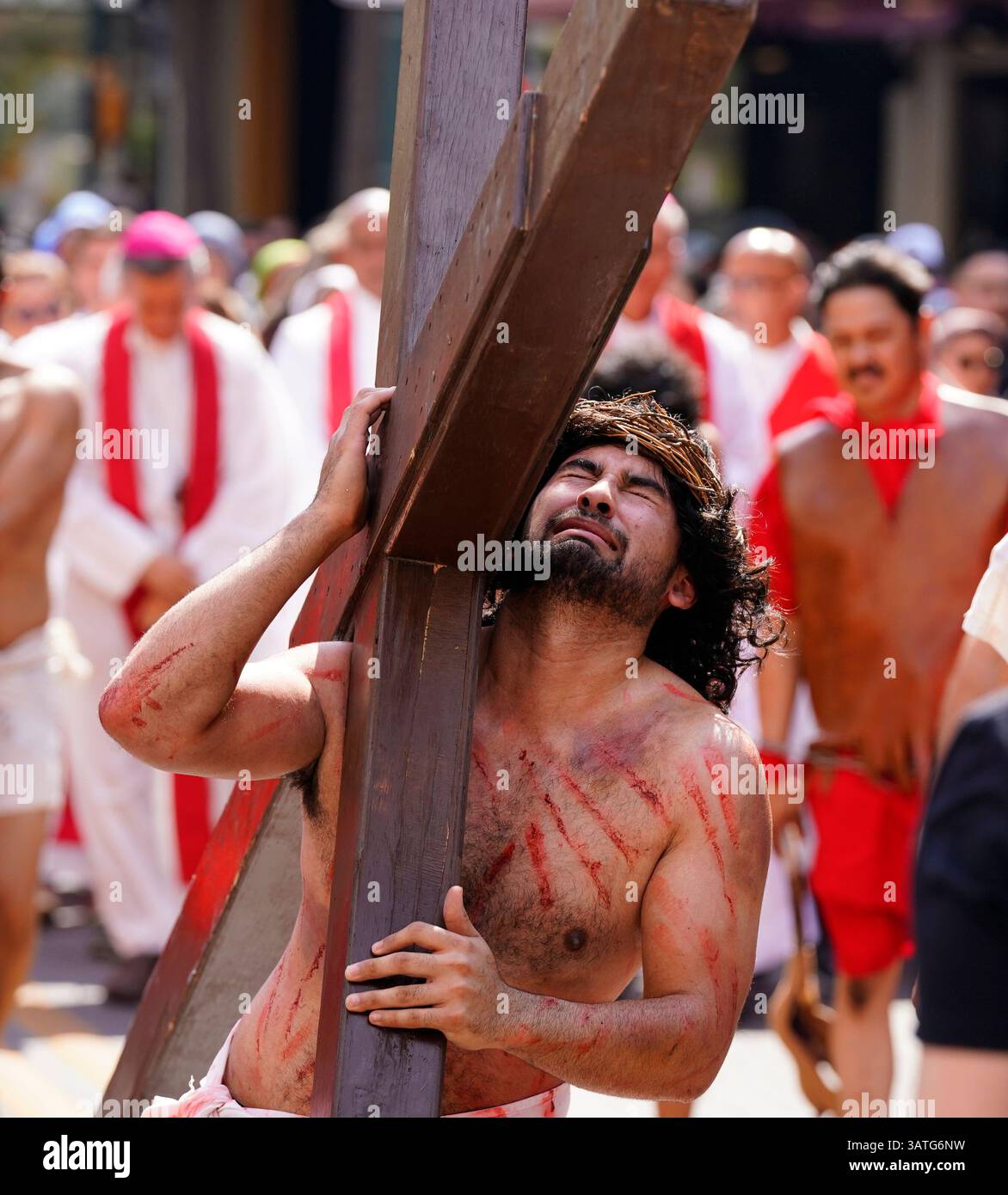Re-Enactors and clergy perform the Good Friday tradition of the Passion of the Christ, the story ...