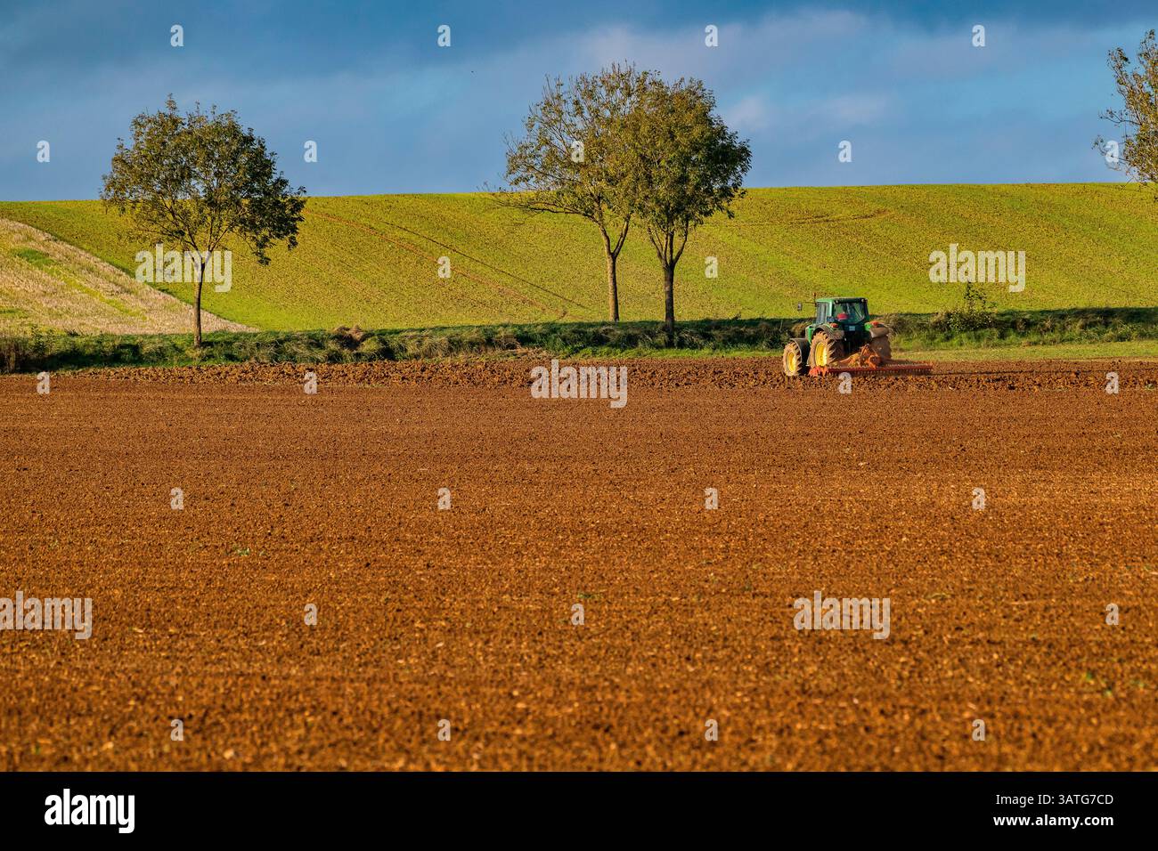 Tractor ploughing in a country landscape, Lorraine, France Stock Photo ...