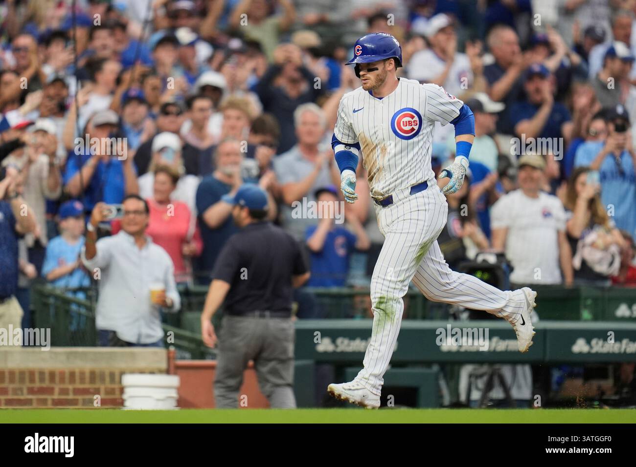 Chicago Cubs' Ian Happ runs the bases after hitting a grand slam during ...